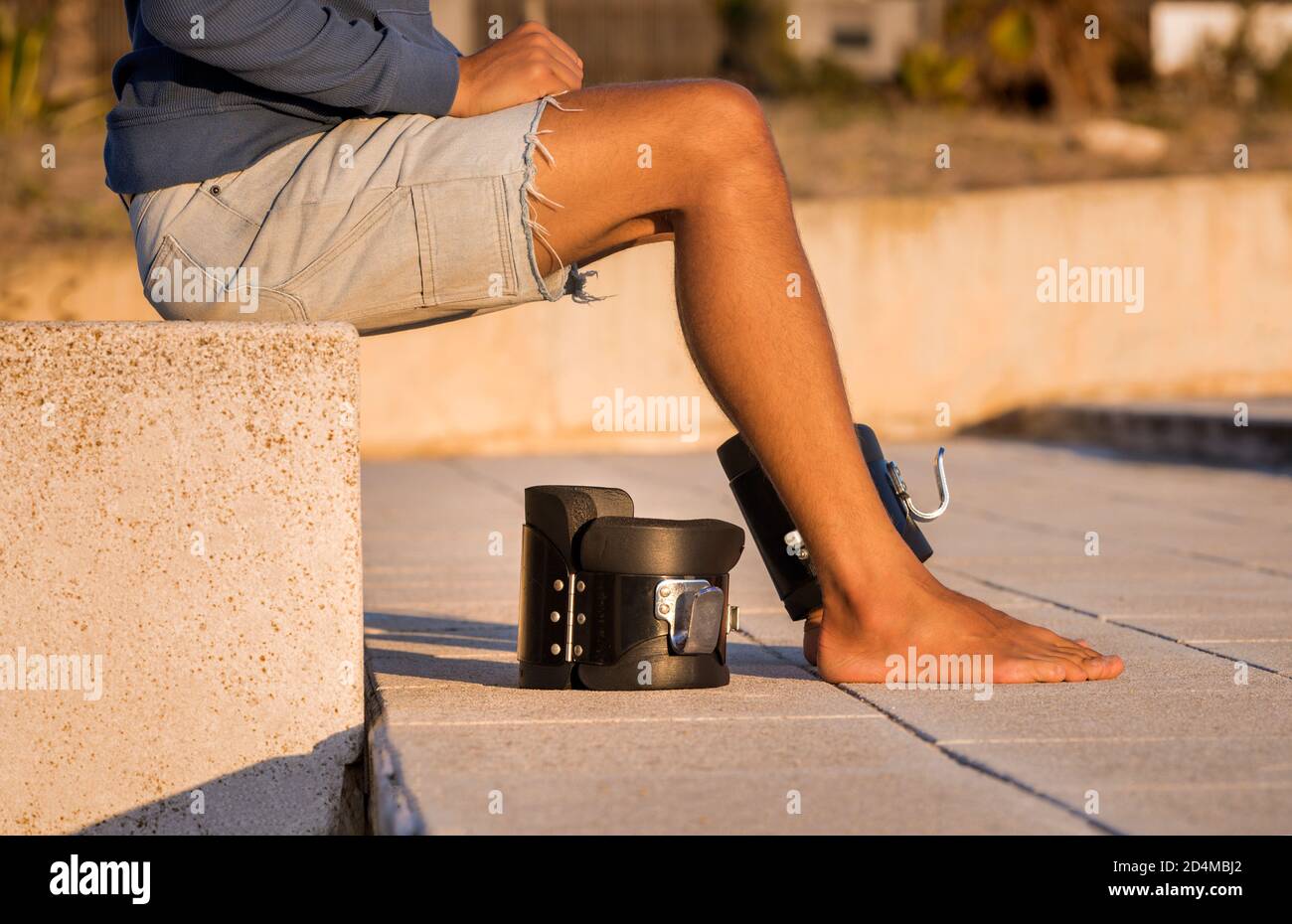 Man putting on anti gravity or inversion boots for upside down hanging ...