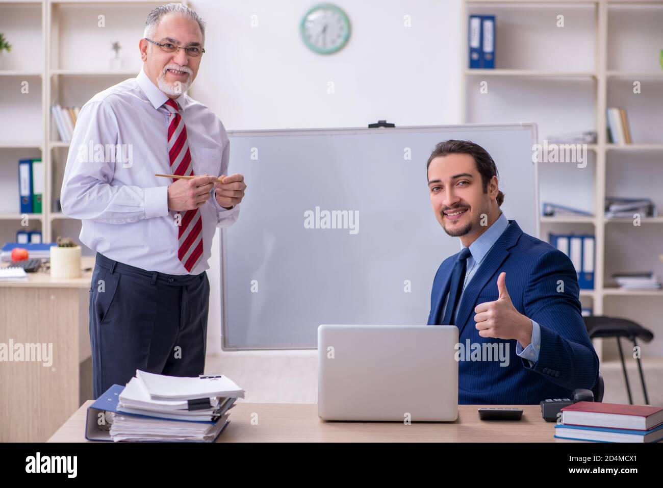 Two employees in the office at business presentation Stock Photo - Alamy