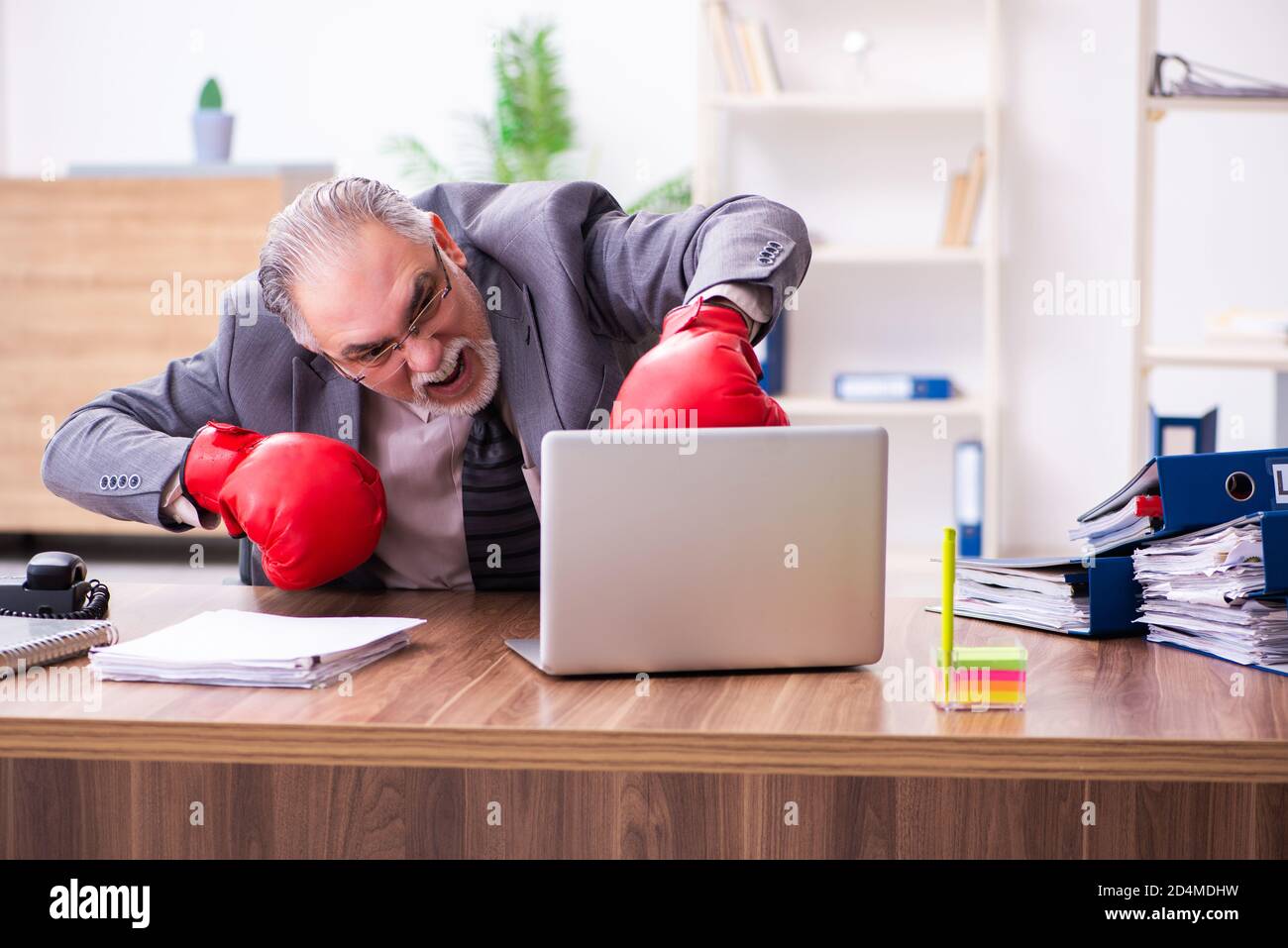 Businessman angry and furious at his workplace Stock Photo - Alamy