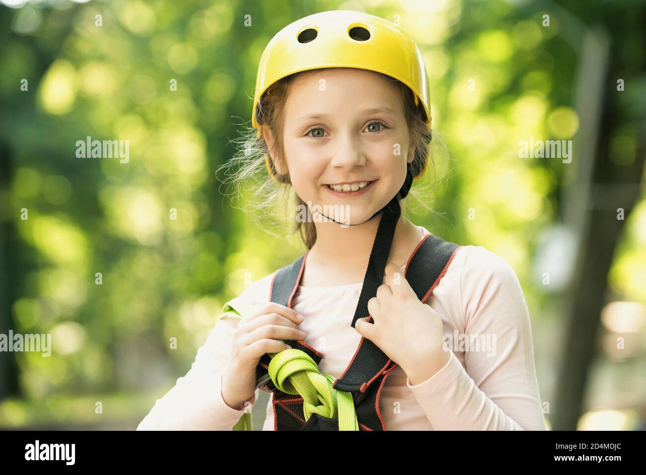 Go Ape Adventure. Happy Little girl climbing on a rope playground ...