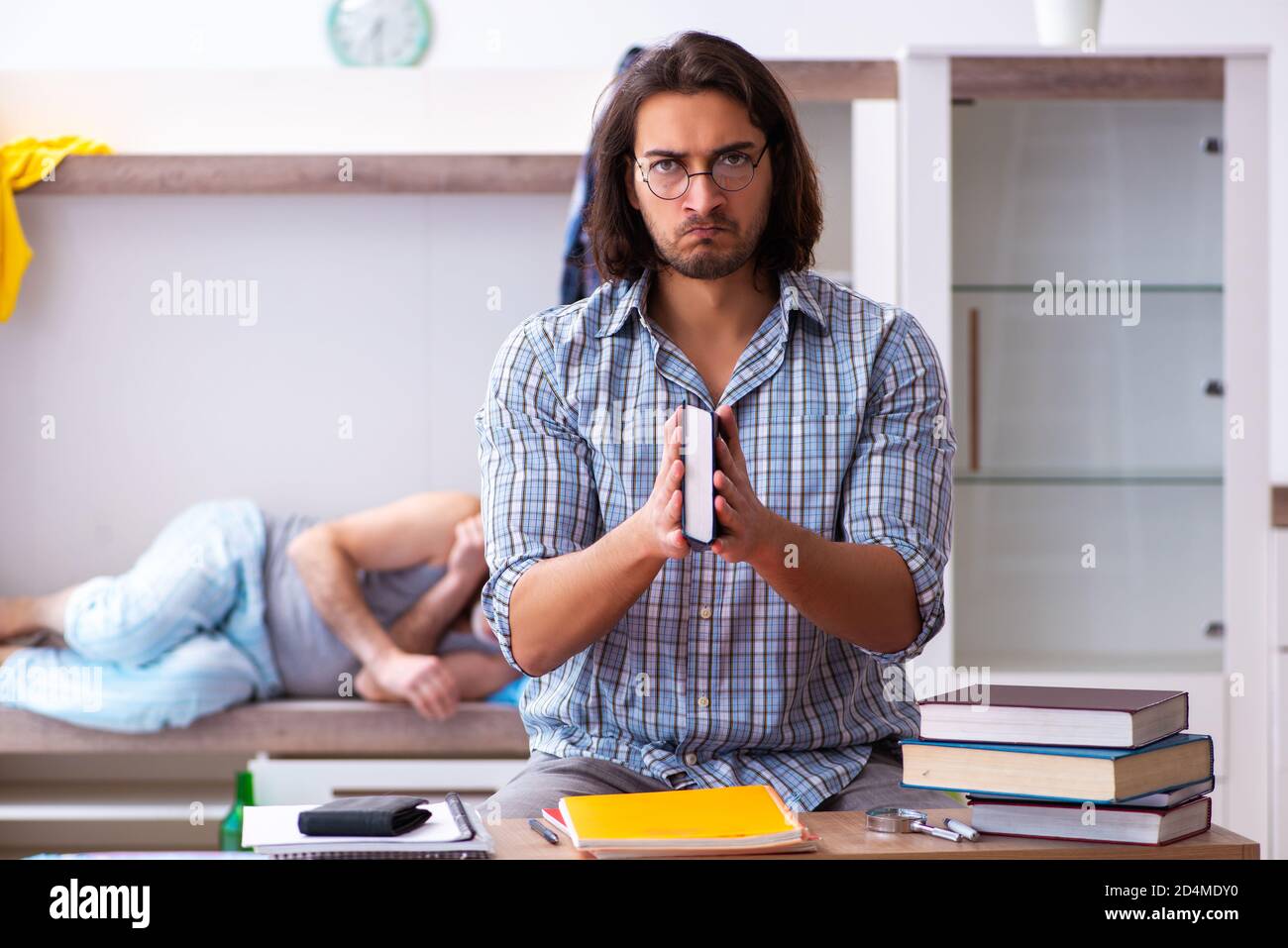 Young son student and dad alcoholic at home Stock Photo - Alamy