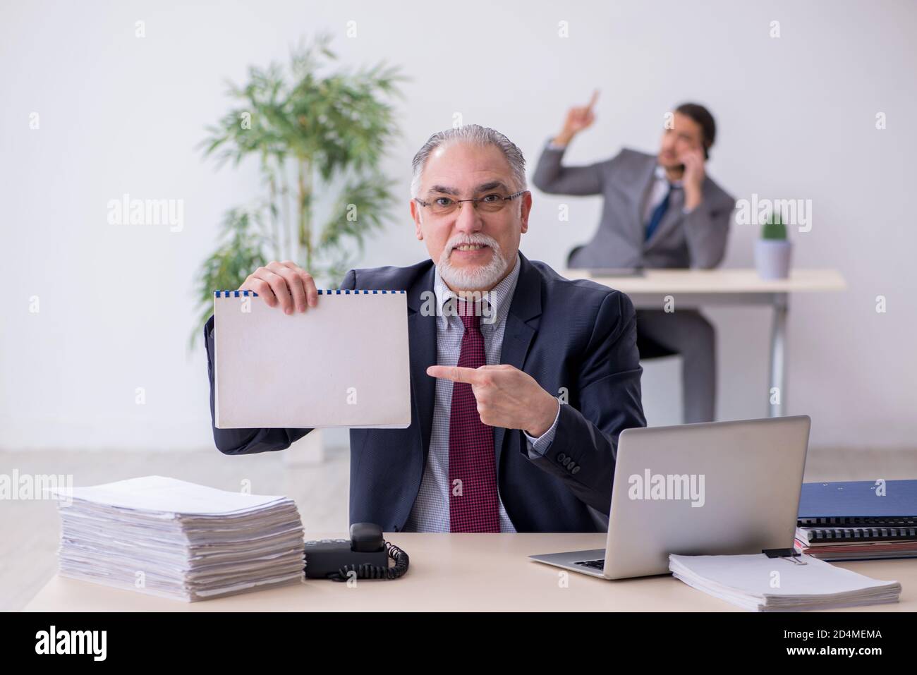 Old boss and his assistant working in the office Stock Photo - Alamy