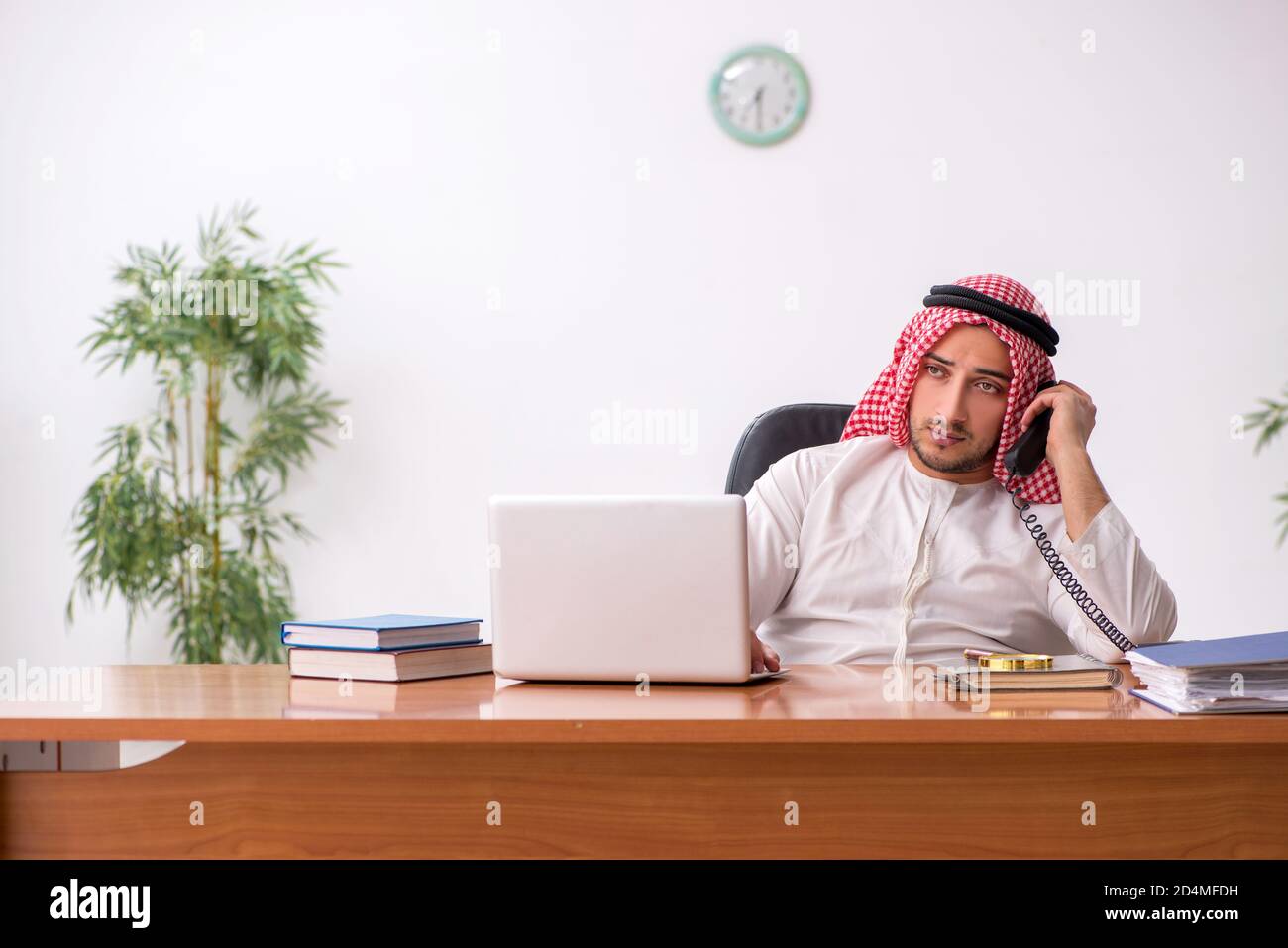 Male arab employee working in the office Stock Photo - Alamy