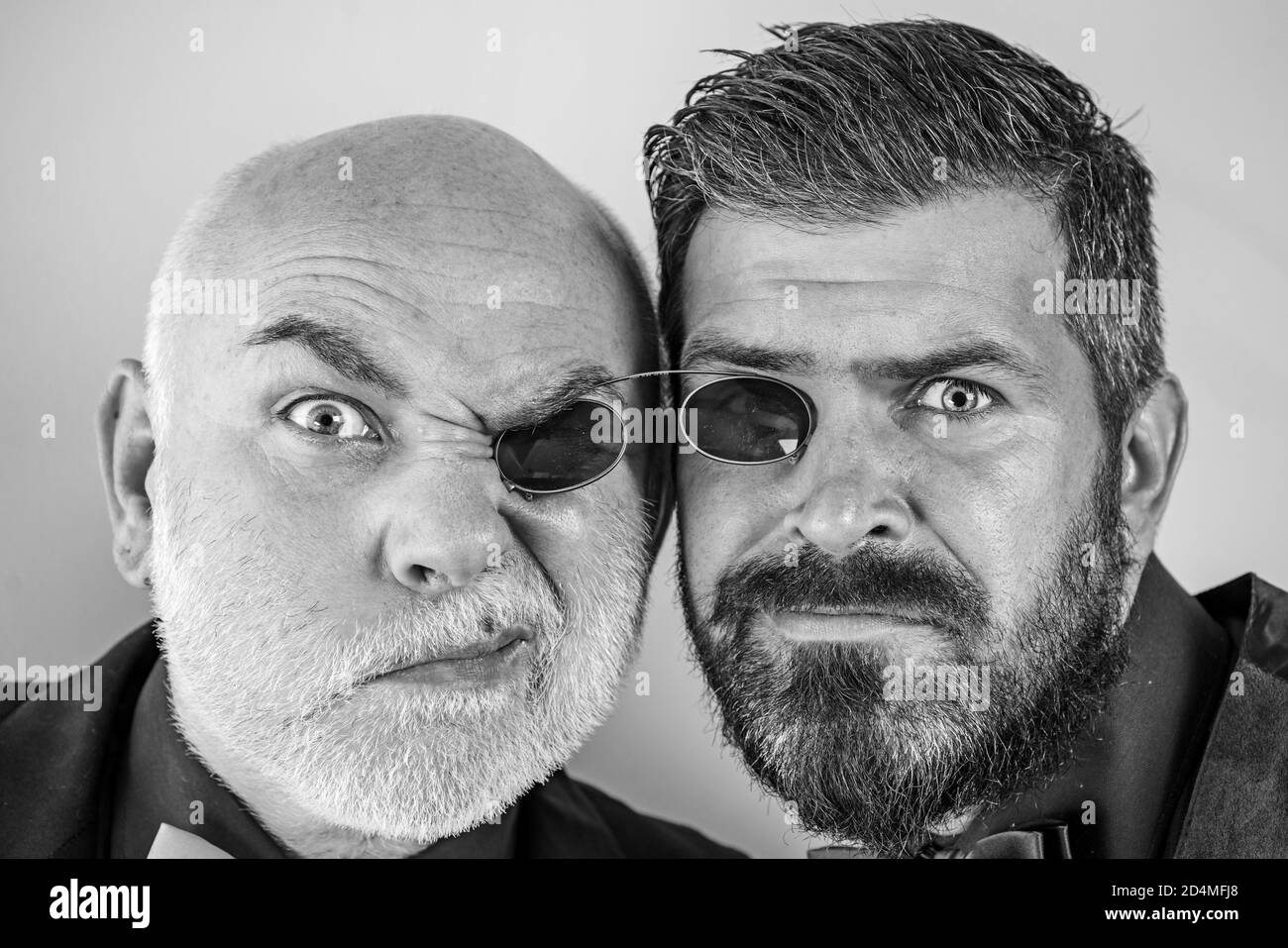 Bearded father and son fooling around in the studio. Glasses. Adult ...
