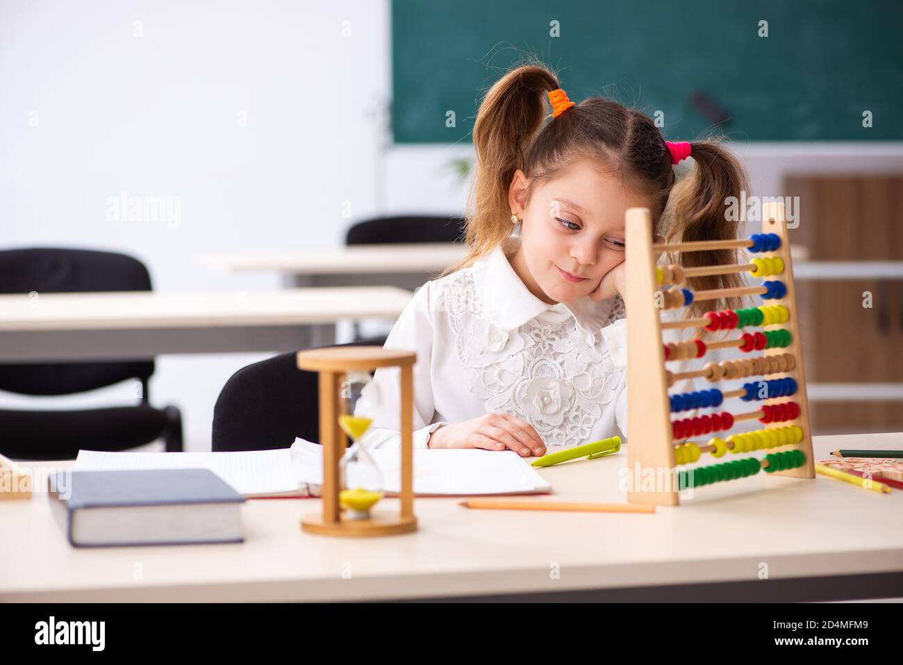 Small girl with the abacus in the classroom Stock Photo - Alamy