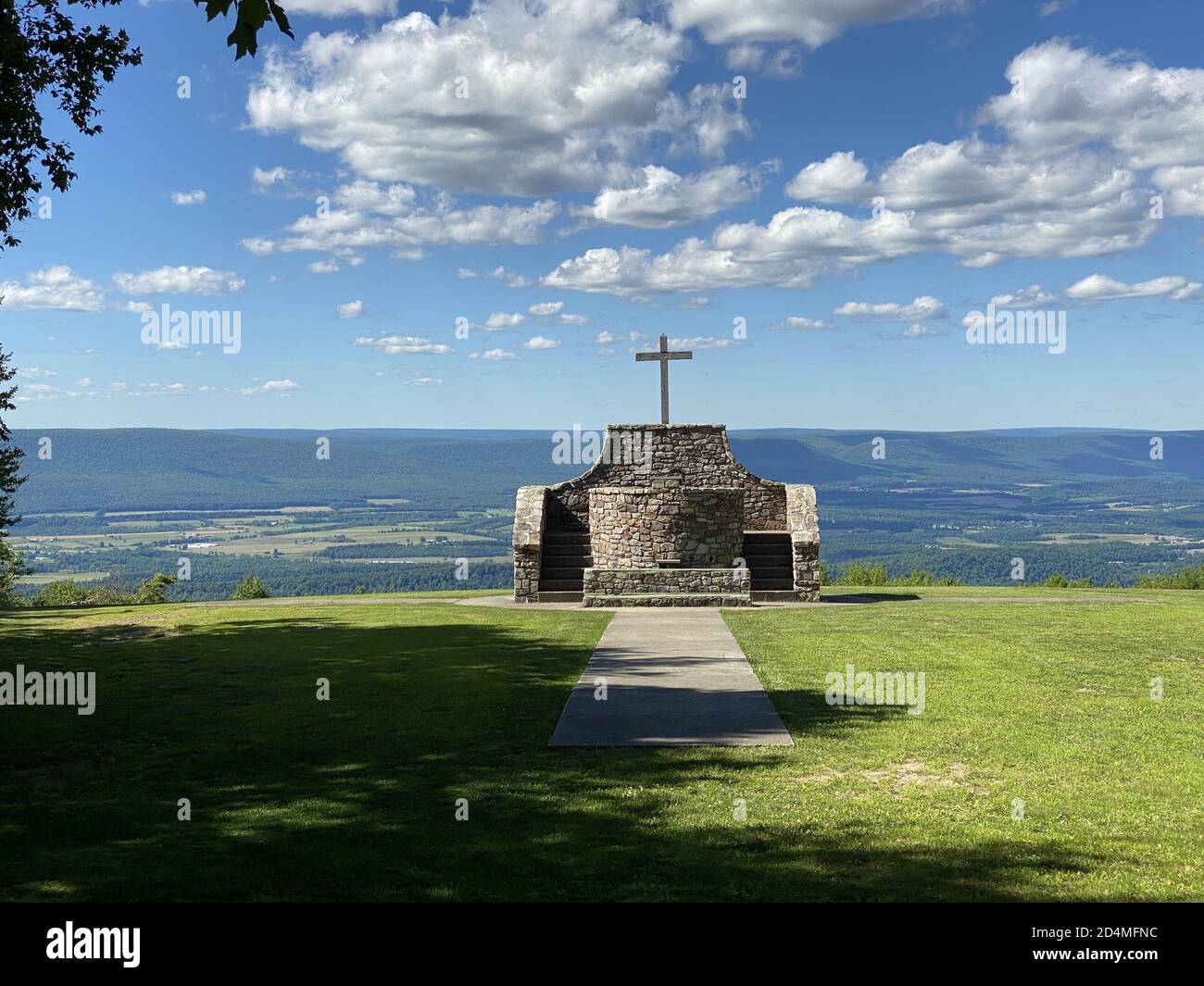 Christian open-air temple in a green area in the background of a plain ...