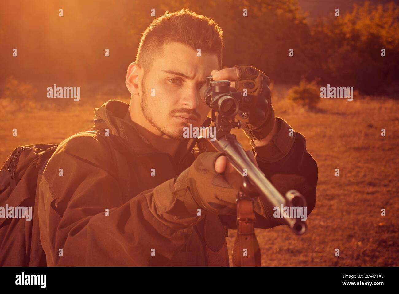 Hunter with Powerful Rifle with Scope Spotting Animals. Rifle Hunter ...