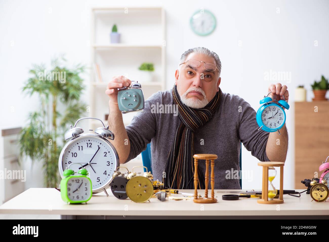Old watchmaker working in the workshop Stock Photo - Alamy