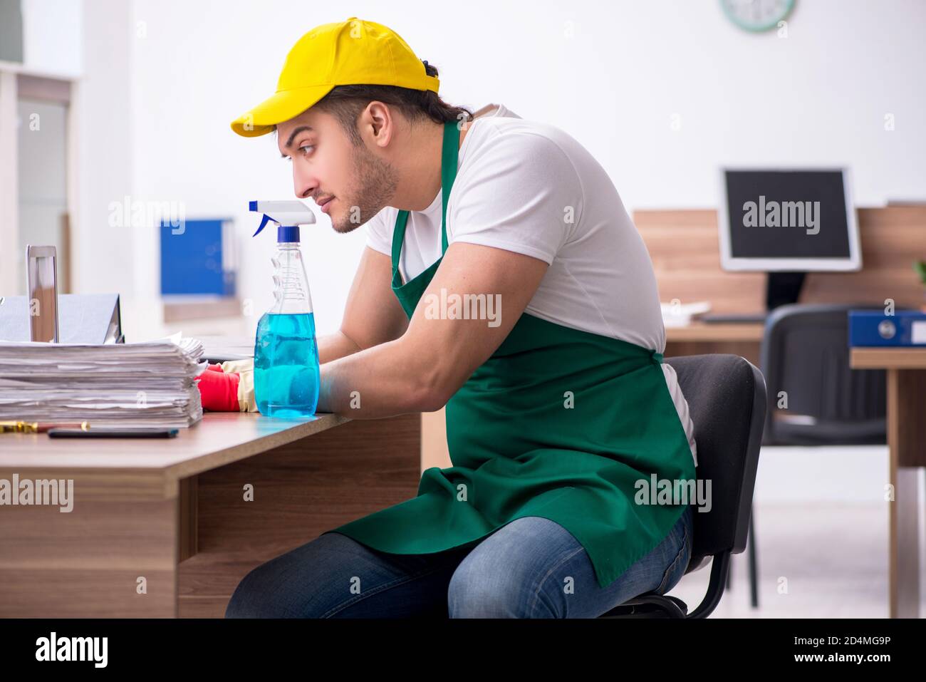 Young contractor cleaning the office Stock Photo - Alamy
