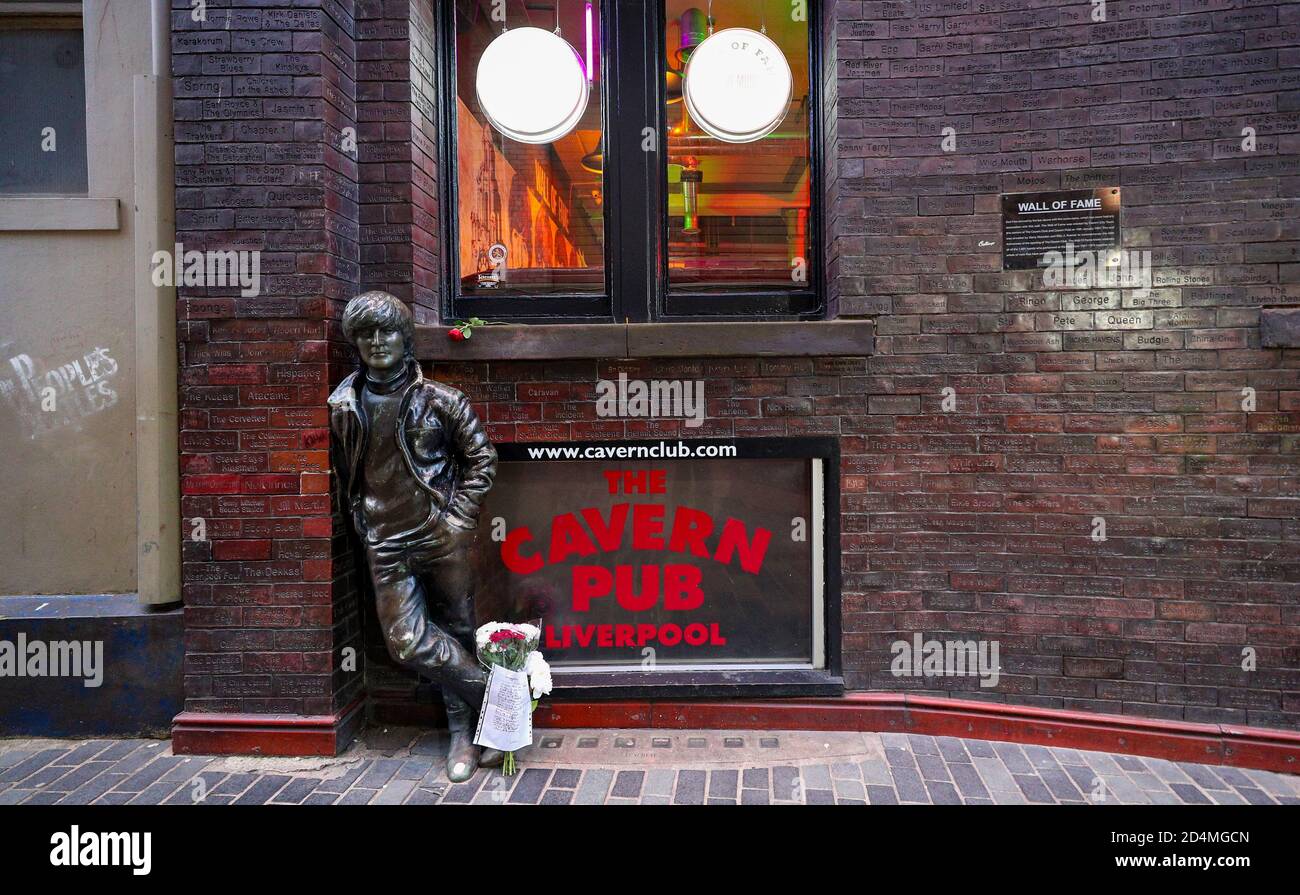 Flowers are left by a statue of John Lennon in Mathew Street, Liverpool ...