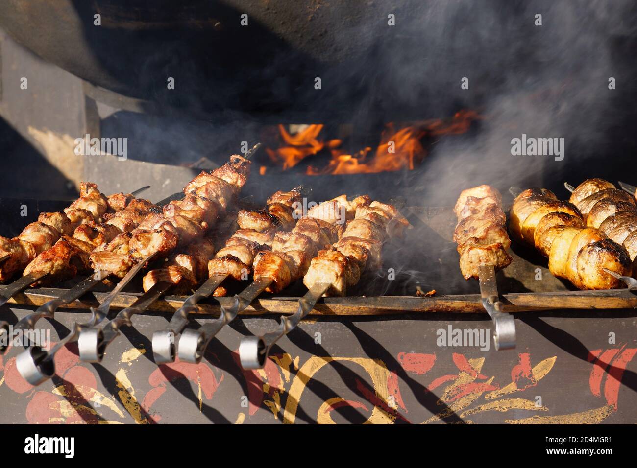 Barbecue. Cooking street food. Meat is fried over an open fire ...