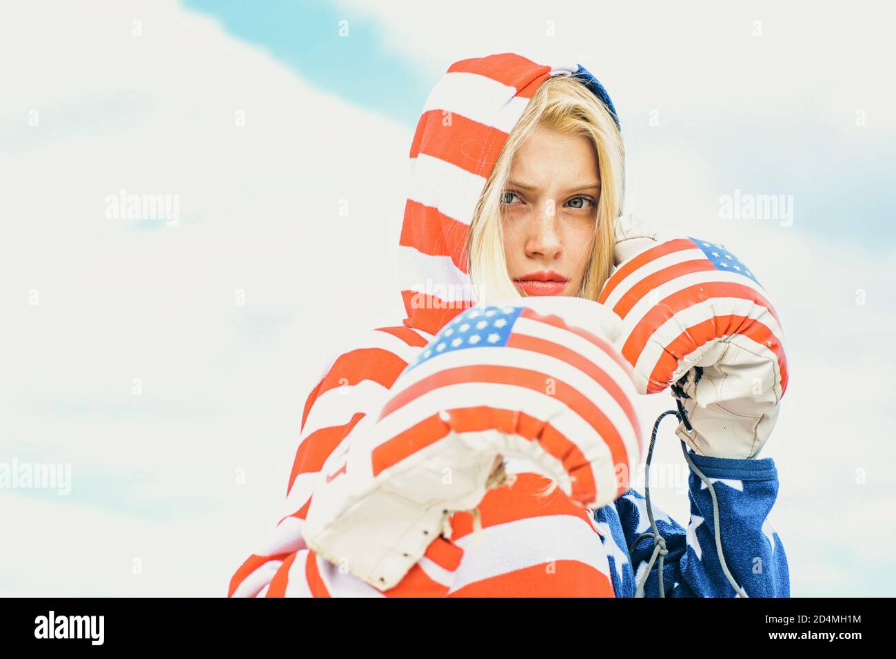 Patriotic holiday. Young beautiful American woman boxer with boxing ...