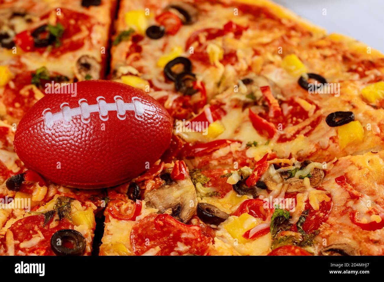 Pepperoni supreme pizza with football ball for american football party ...