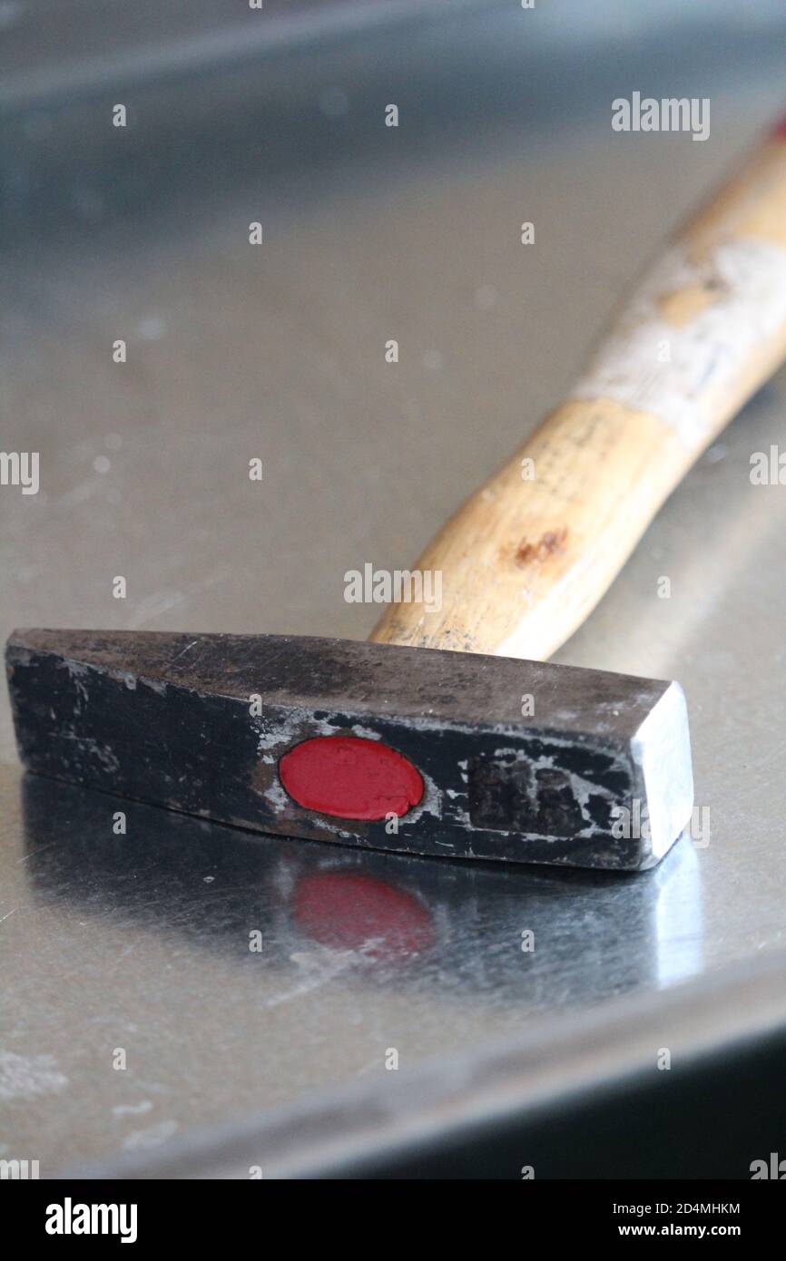 Closeup shot of the old and used hammer on the steel surface Stock ...
