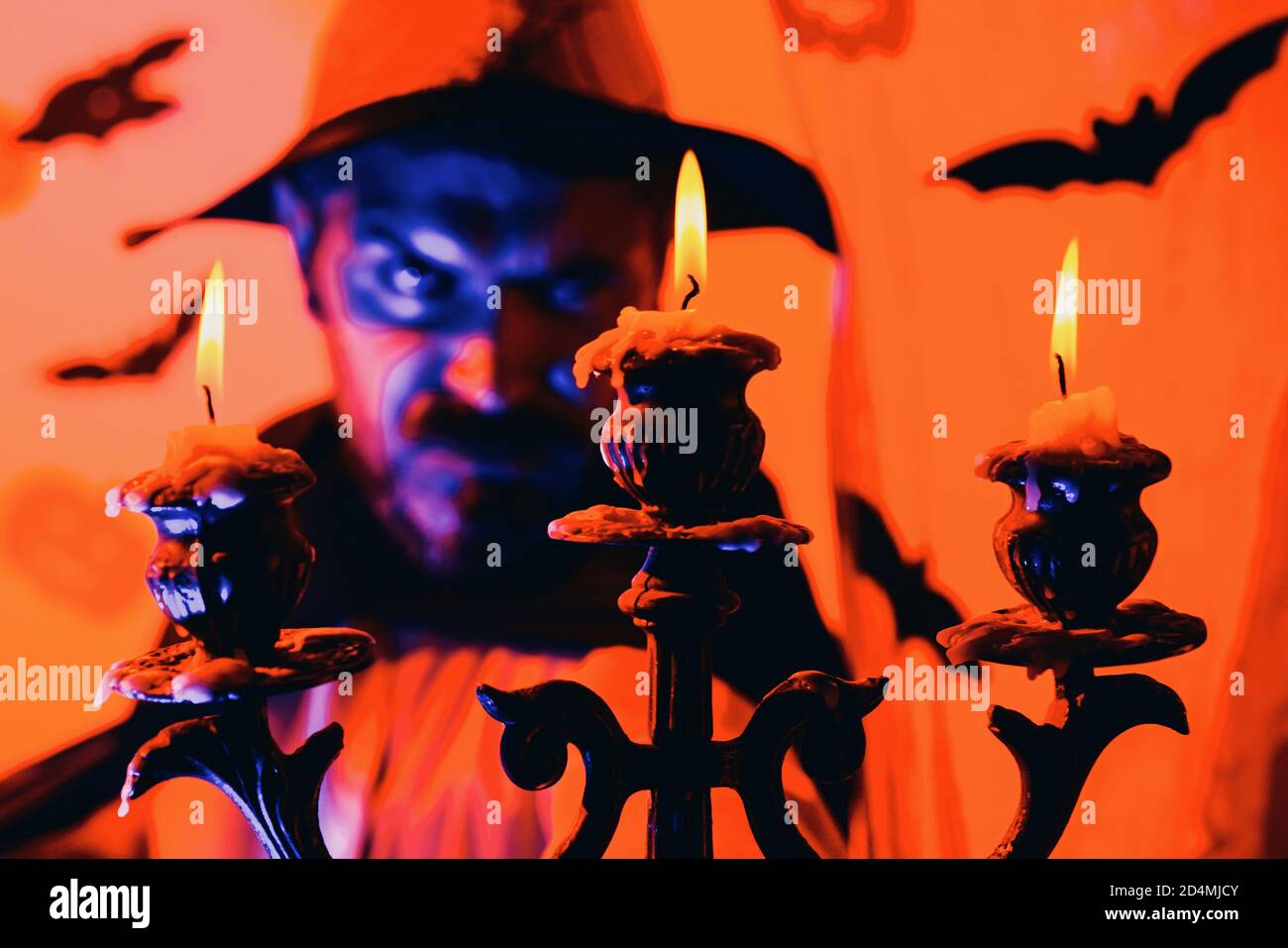 Evil witcher with red hair and a beard in a black cloak reading a book ...