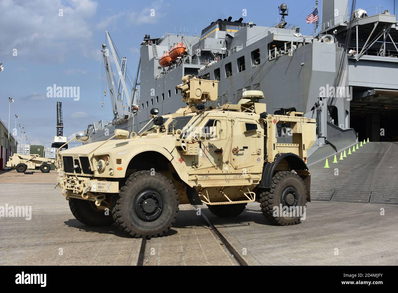 A mine resistant ambush protected vehicle awaits on a dock after being ...