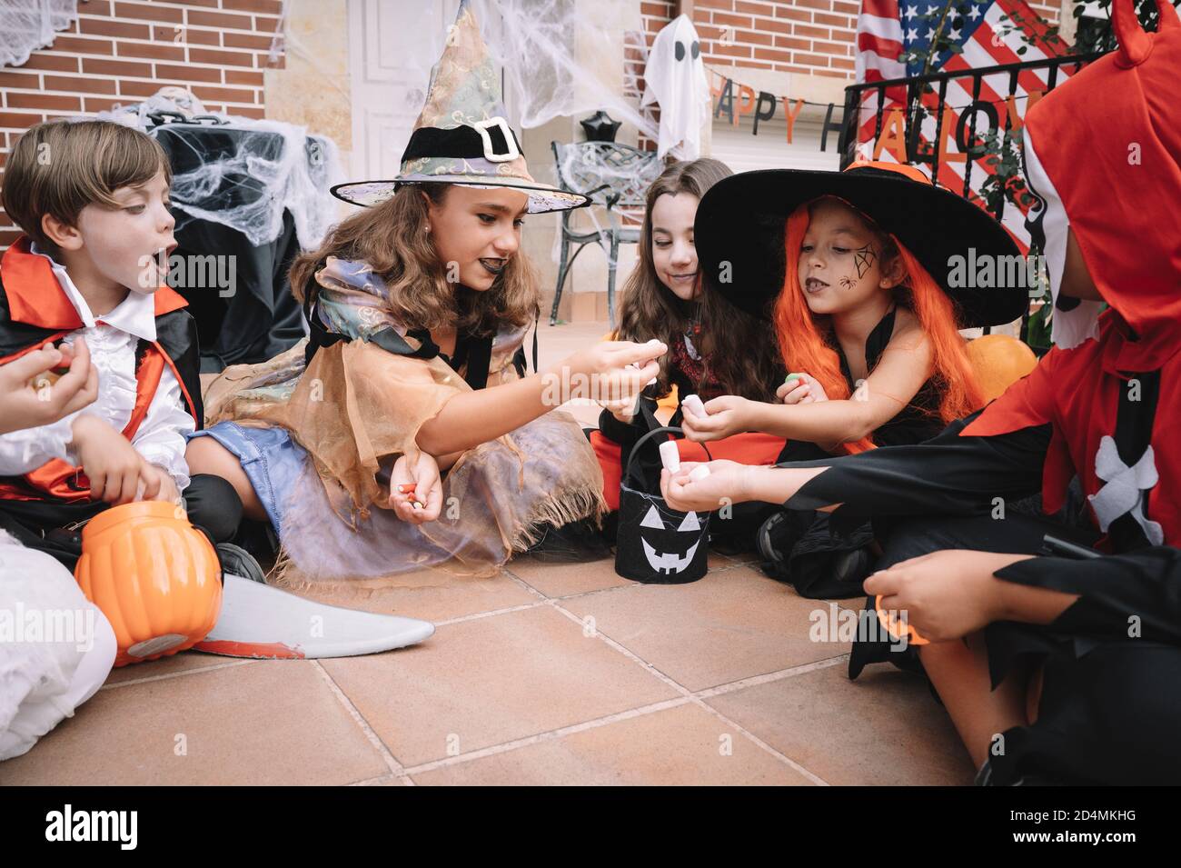 Children sharing and comparing their candies on halloween Stock Photo ...