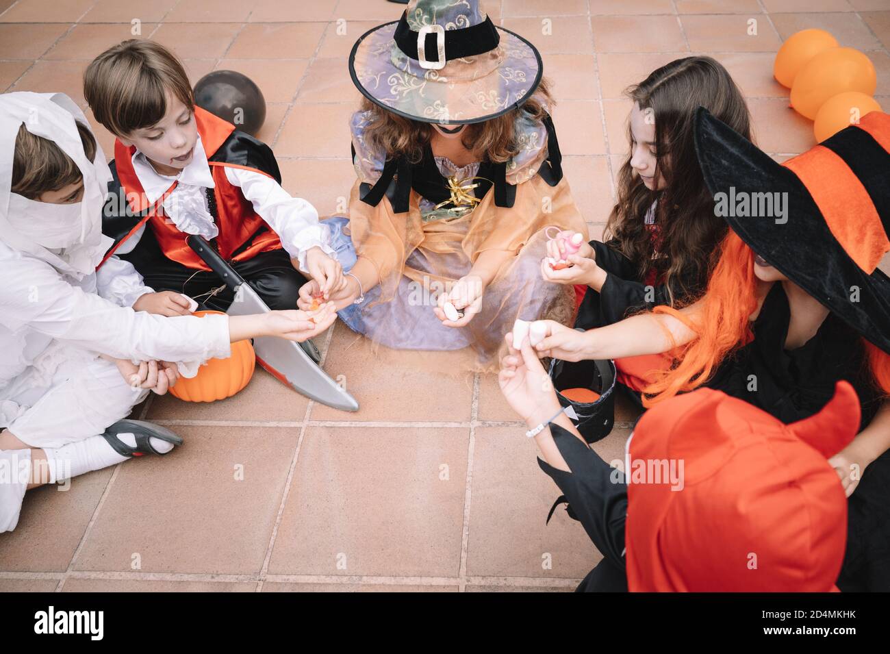 Children sharing and comparing their candies on halloween Stock Photo ...