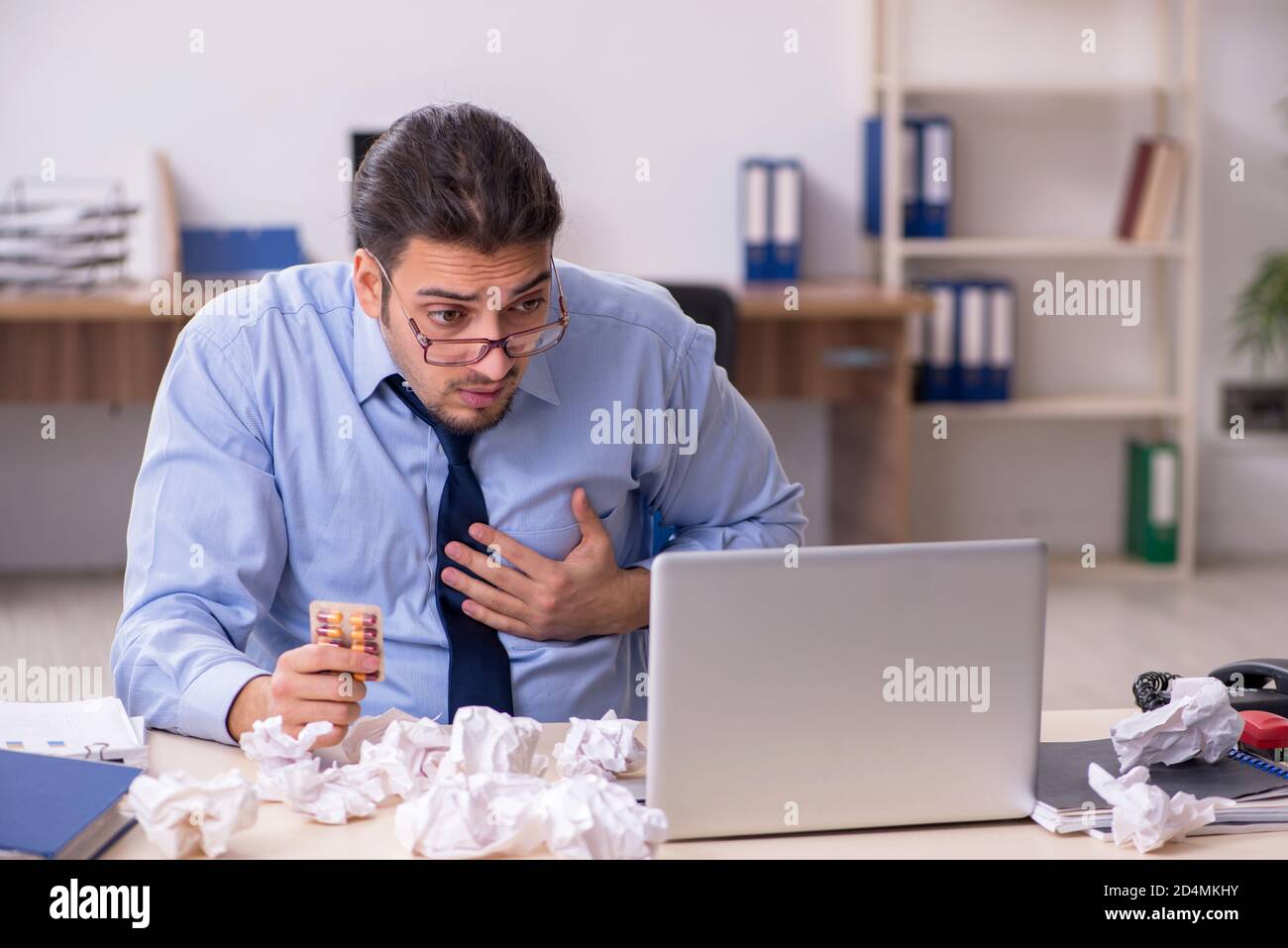 Sick male employee suffering at the workplace Stock Photo - Alamy