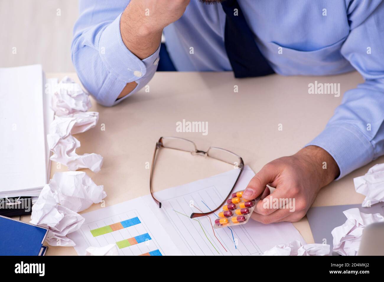 Sick male employee suffering at the workplace Stock Photo - Alamy