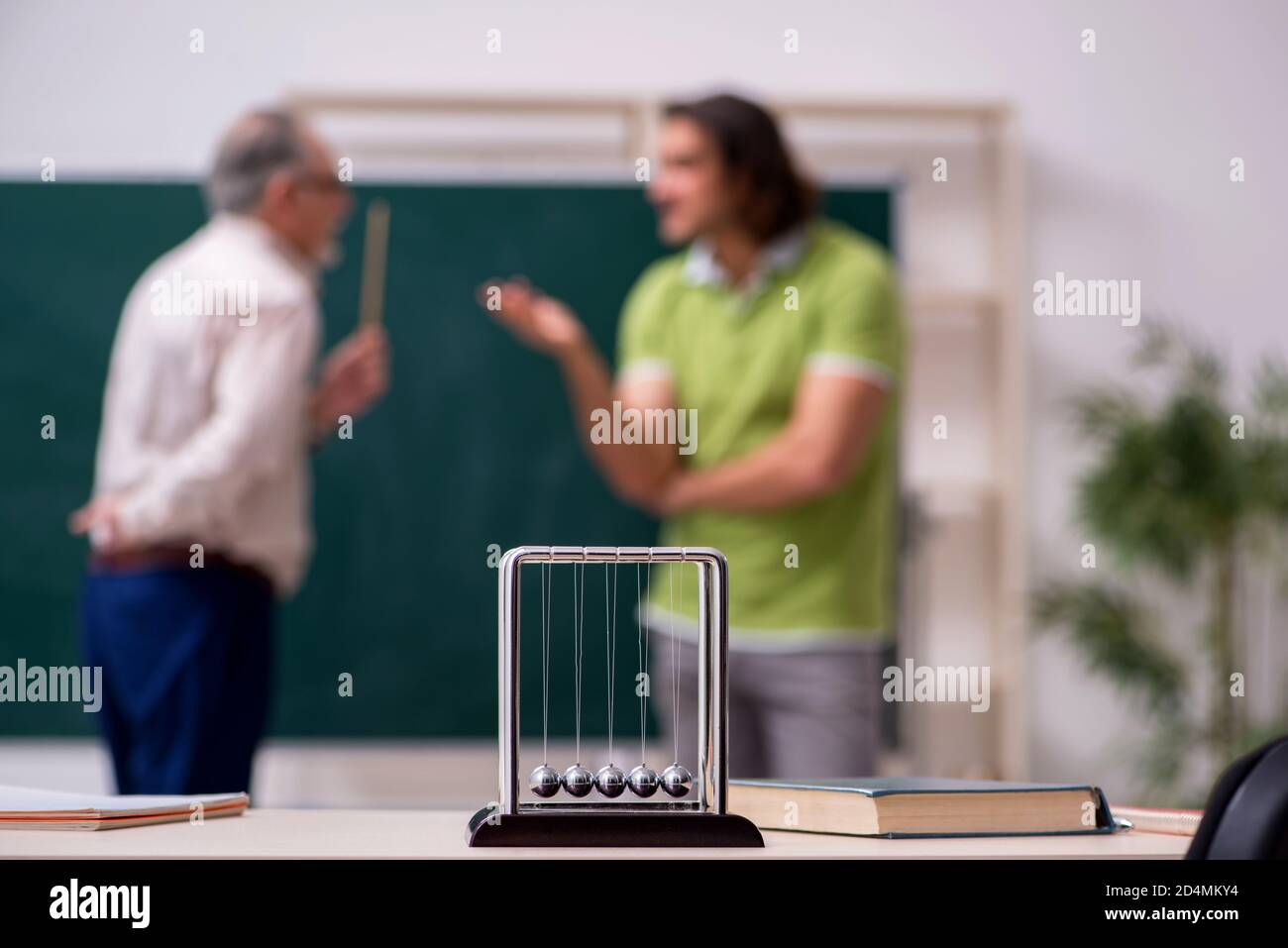 Old professor physicist and student in the classroom Stock Photo - Alamy