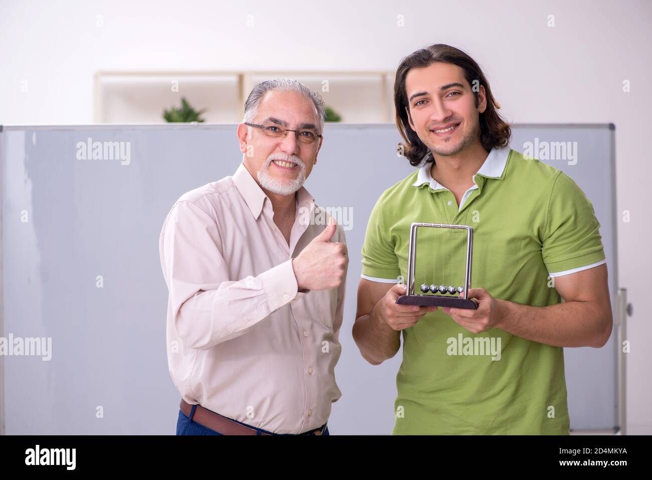 Old professor physicist and student in the classroom Stock Photo - Alamy
