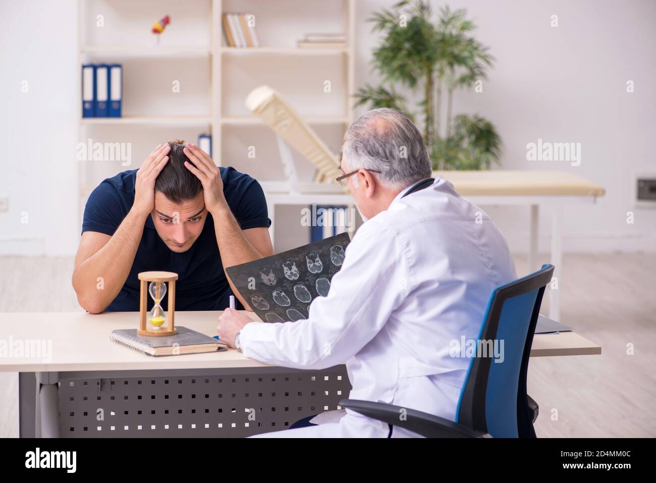 Male patient visiting doctor radiologist in time management concept ...