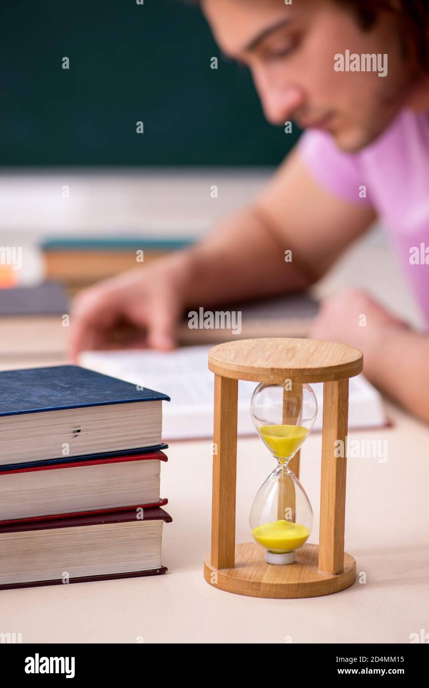 Young student in the classroom at time management concept Stock Photo ...