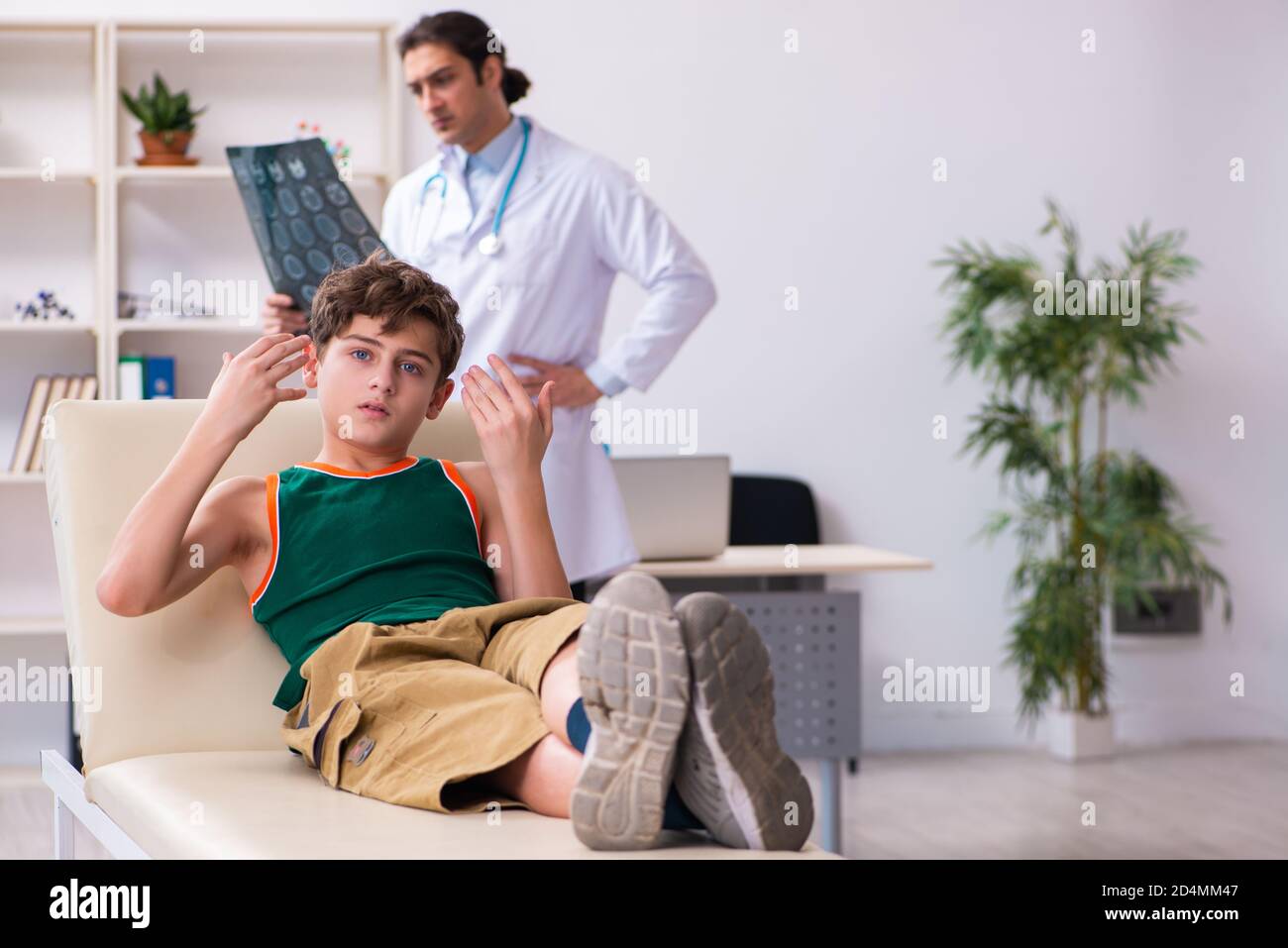 Sick boy visiting young doctor pediatrician Stock Photo - Alamy