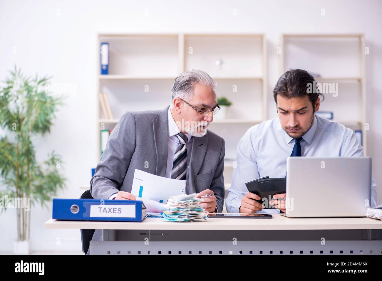 The two accountants working in the office Stock Photo - Alamy