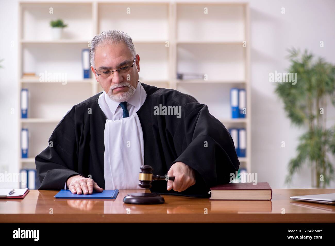 Old judge working in courthouse Stock Photo - Alamy