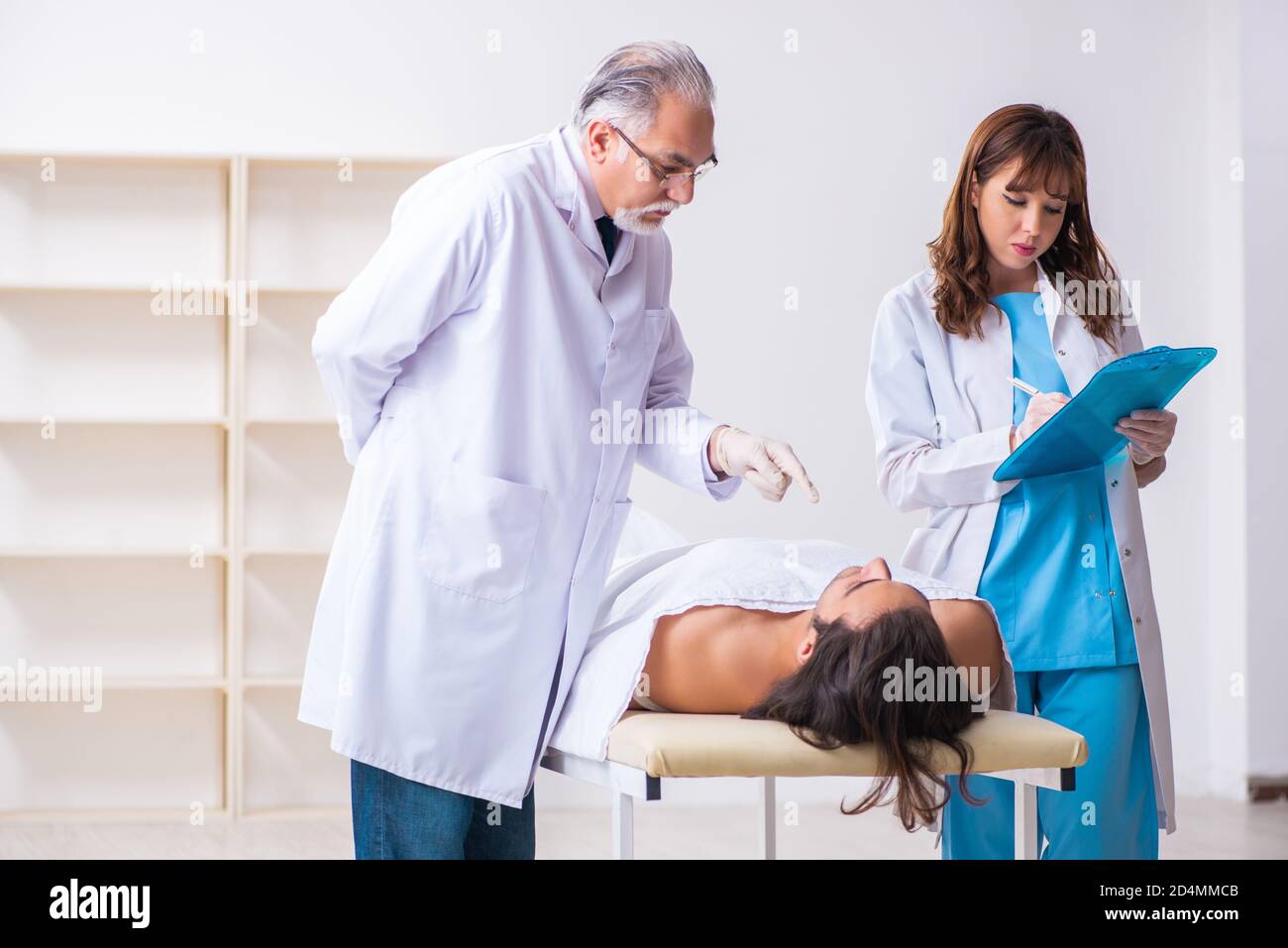 Police coroner examining dead body corpse in the morgue Stock Photo - Alamy