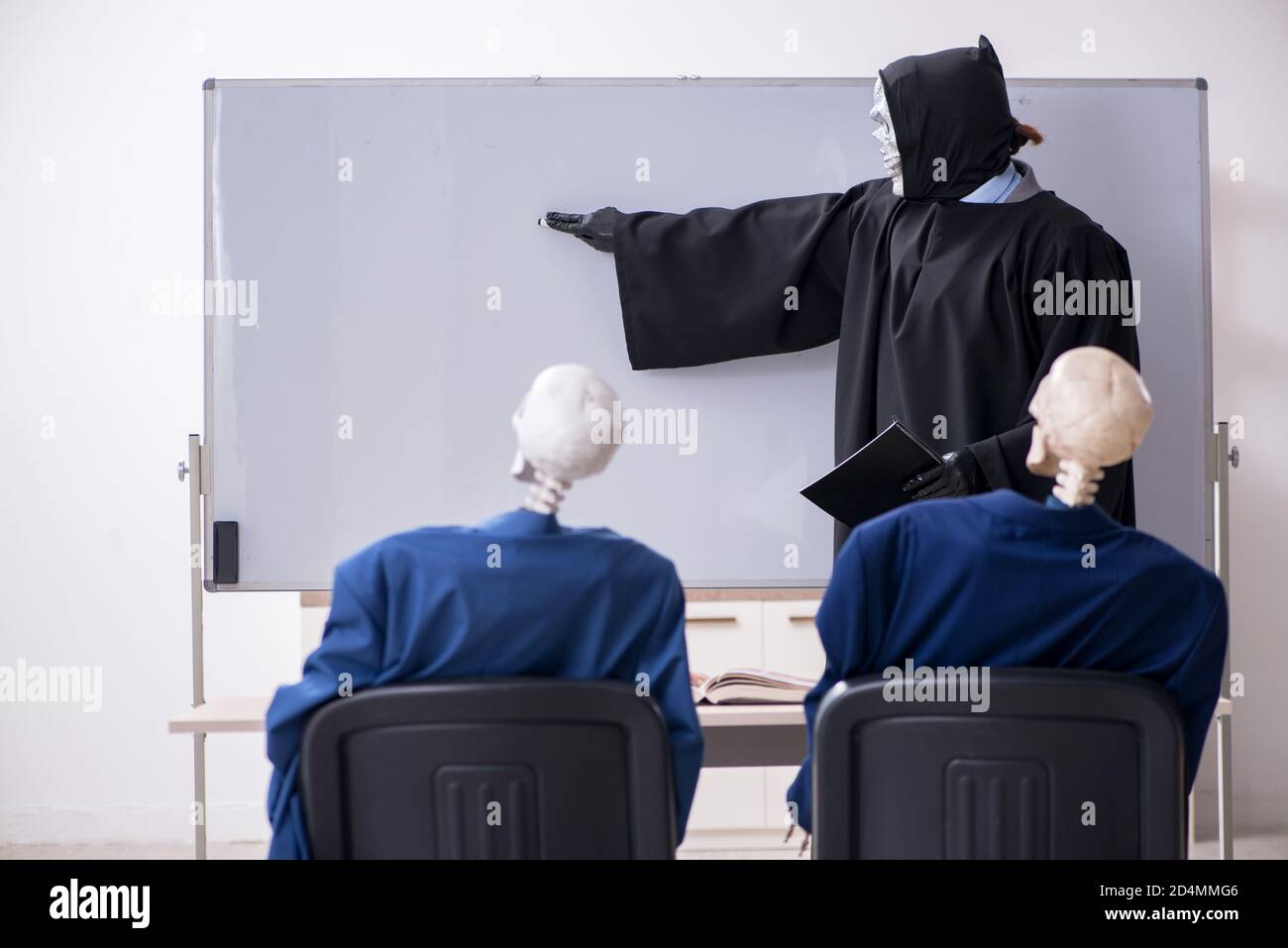 Funny business meeting with the devil and skeletons Stock Photo - Alamy