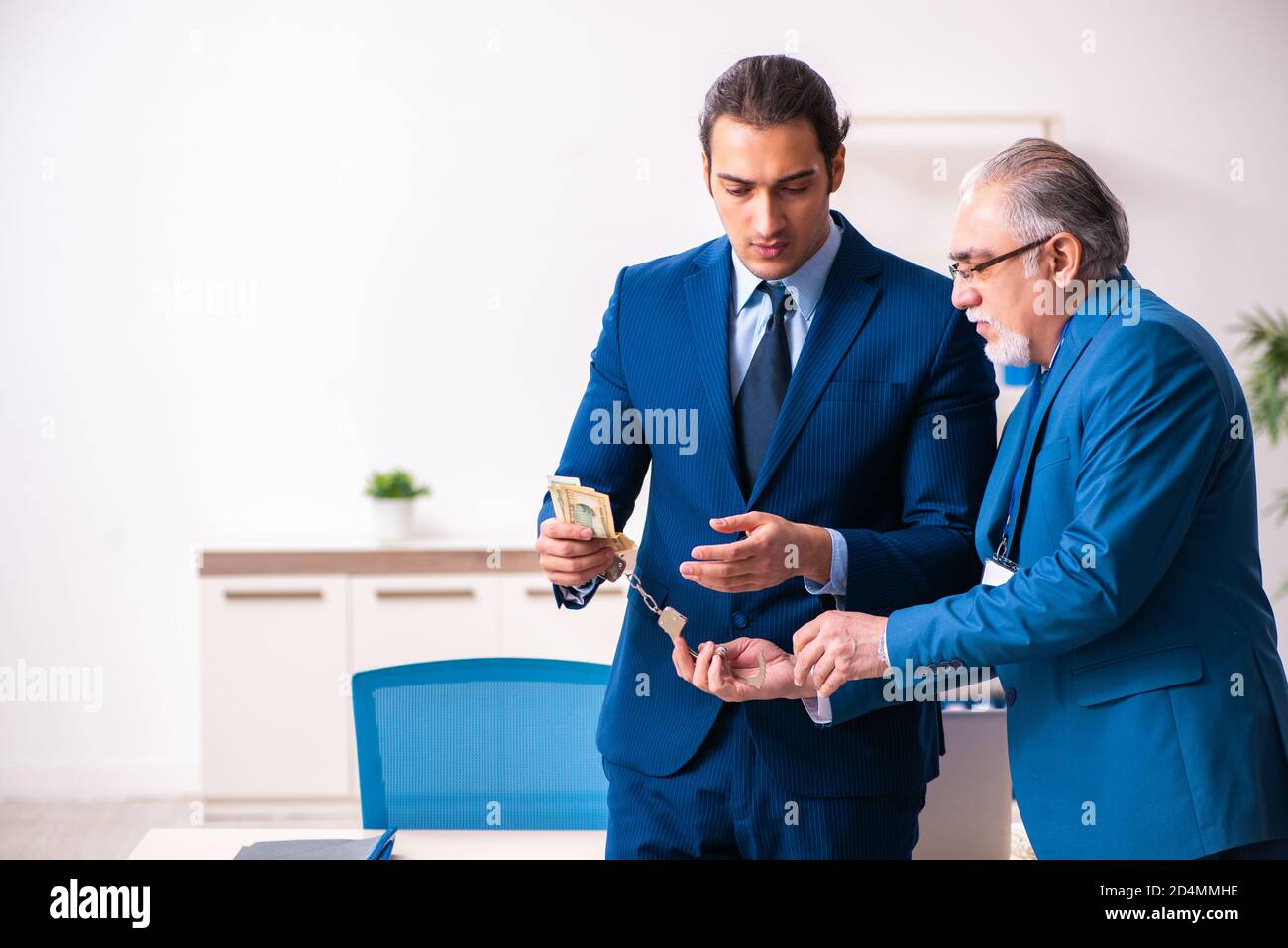 Male employee and cop in police investigation Stock Photo - Alamy