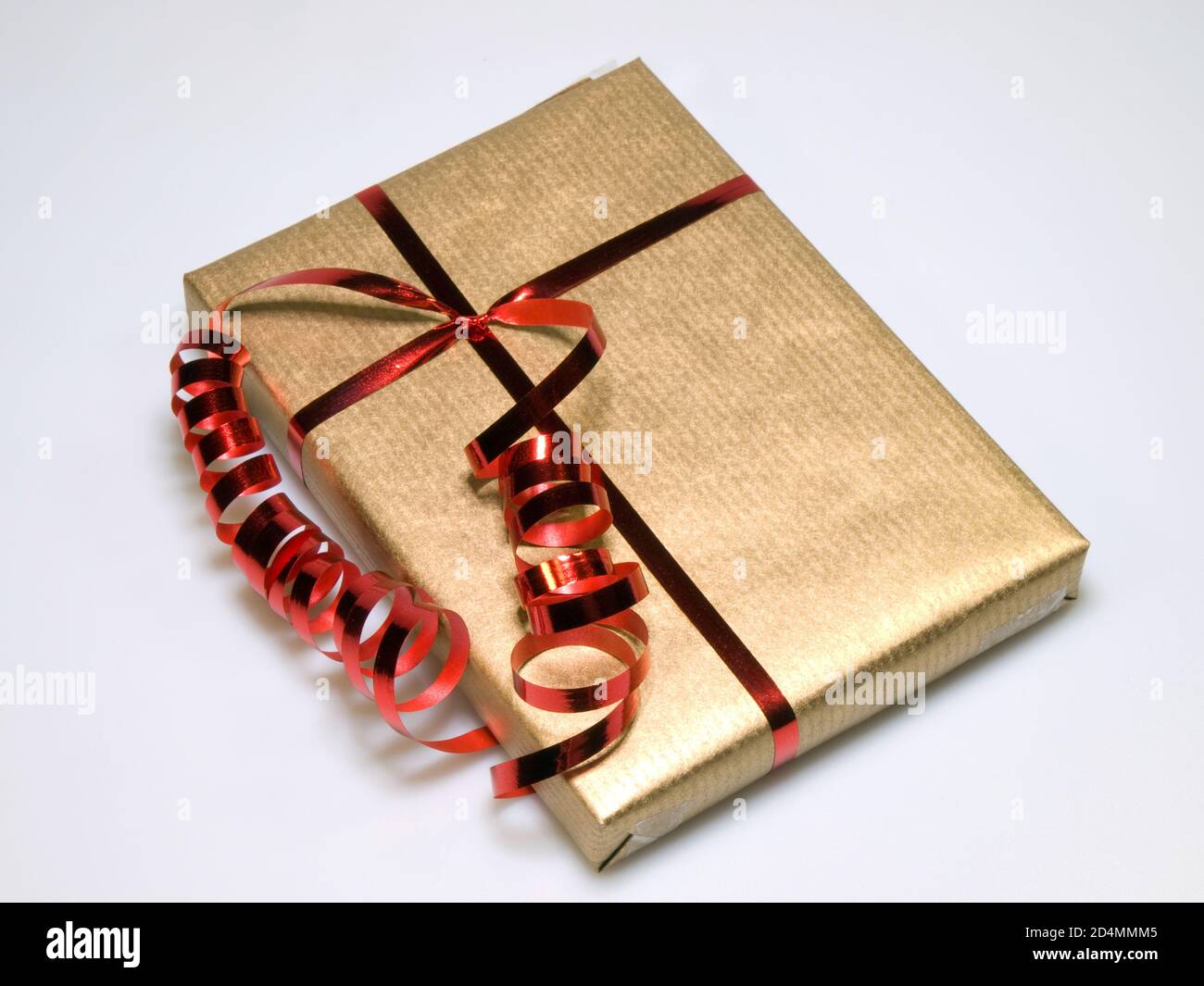 Present wrapped in gold and red Stock Photo - Alamy