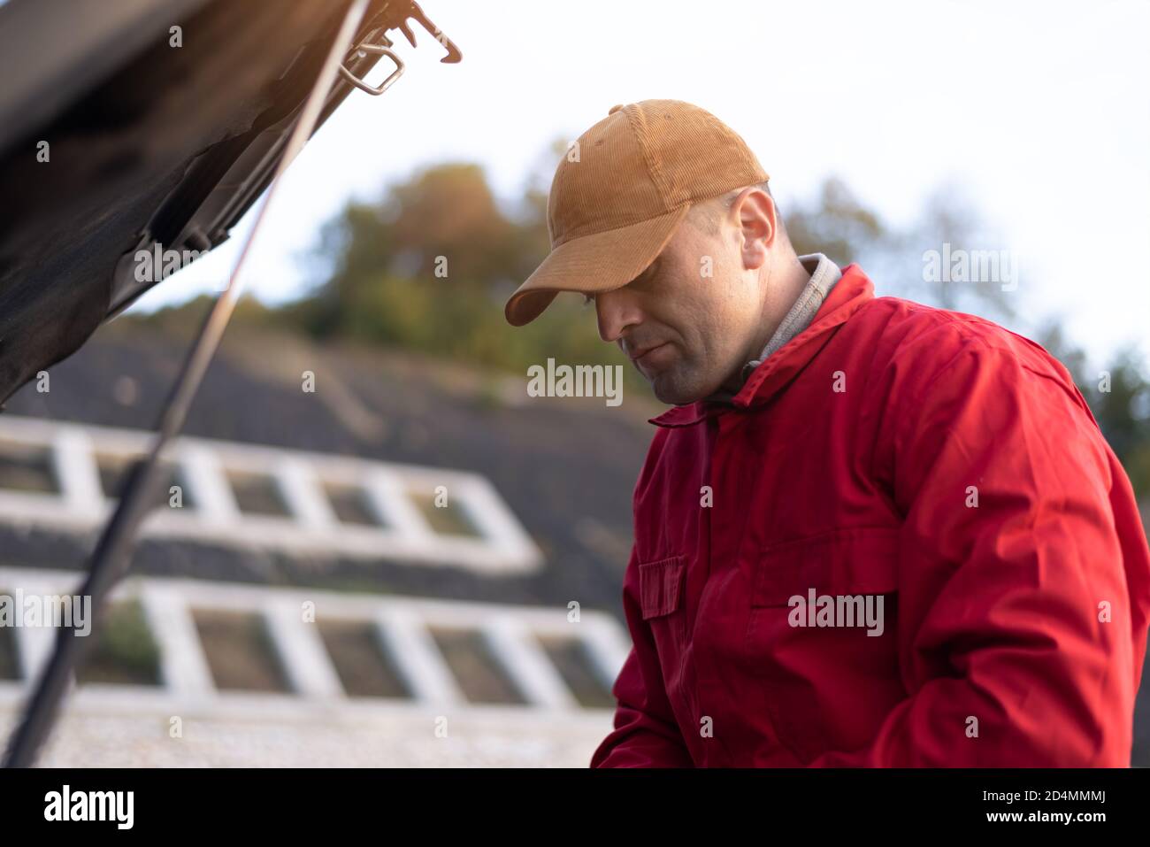 Emergency roadside assistance, road assistance worker in uniform trying ...