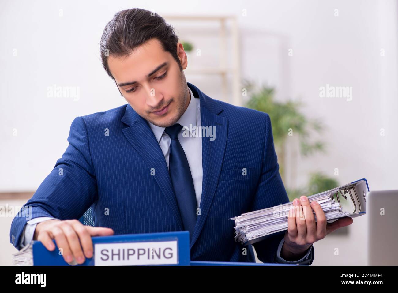 Young logistics specialist working in the office Stock Photo - Alamy