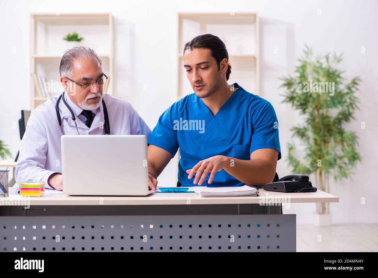 Two male doctors working in the modern clinic Stock Photo - Alamy