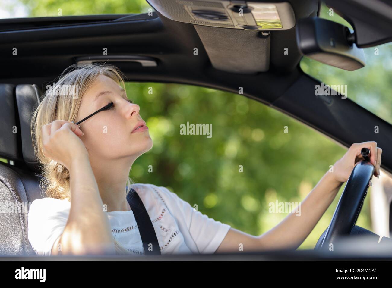 Woman applying mascara driving hi-res stock photography and images - Alamy
