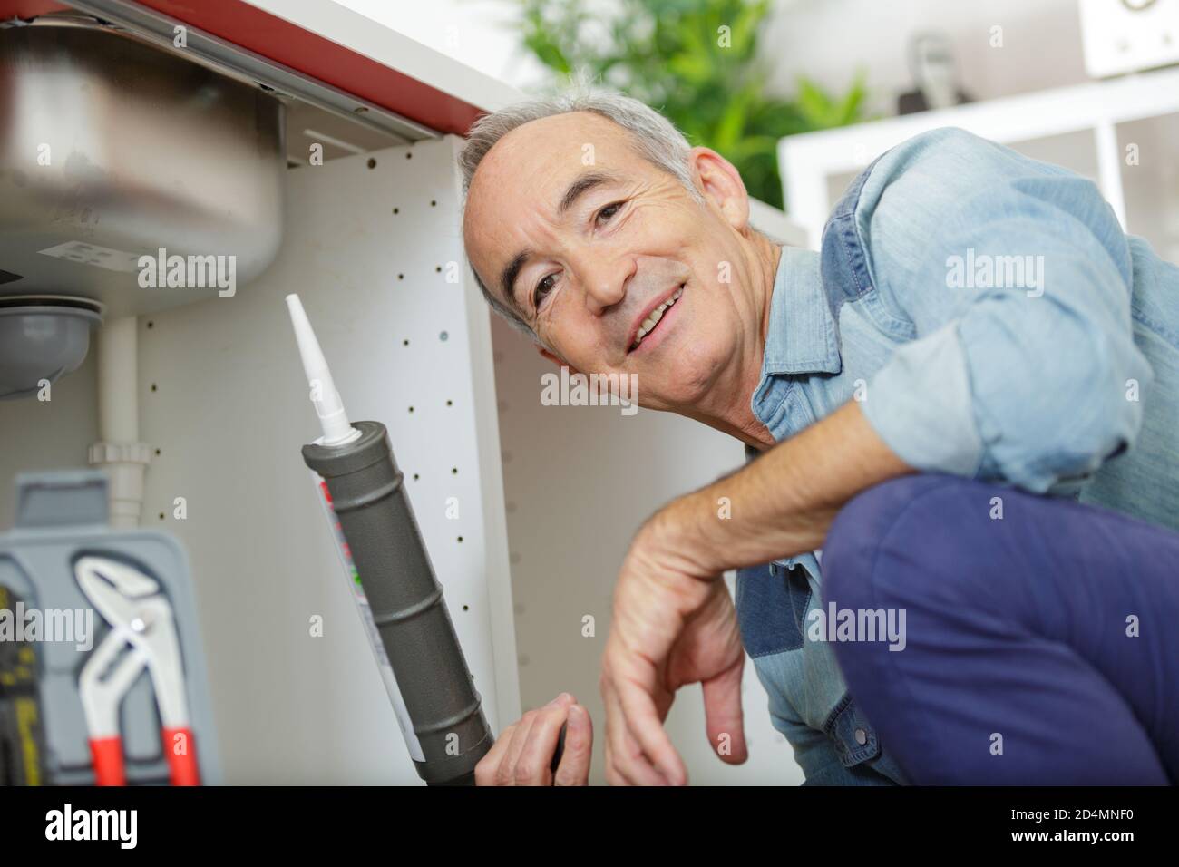 Worker hands applying silicone hi-res stock photography and images - Alamy