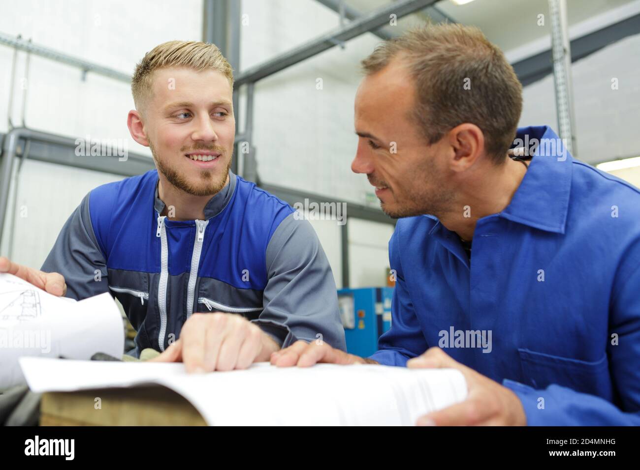 portrait of two workmen in workshop Stock Photo - Alamy