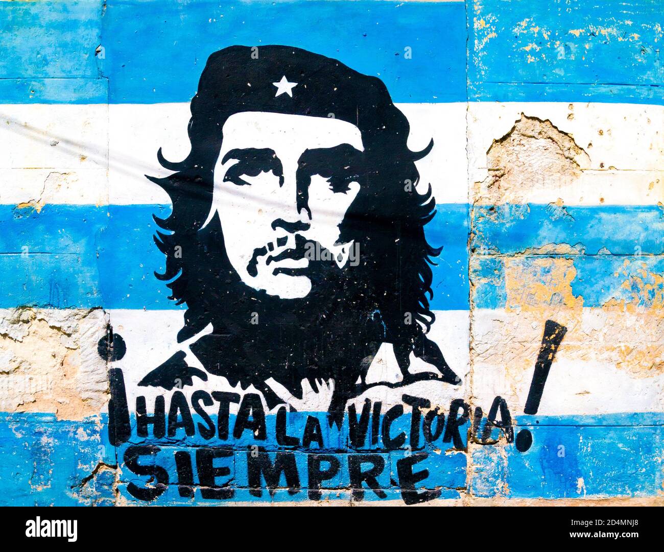 Painting of Che Guevara and a revolutionary slogan on a weathered old ...