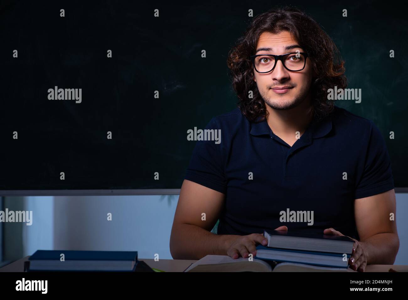 Young student in the classroom at night Stock Photo - Alamy