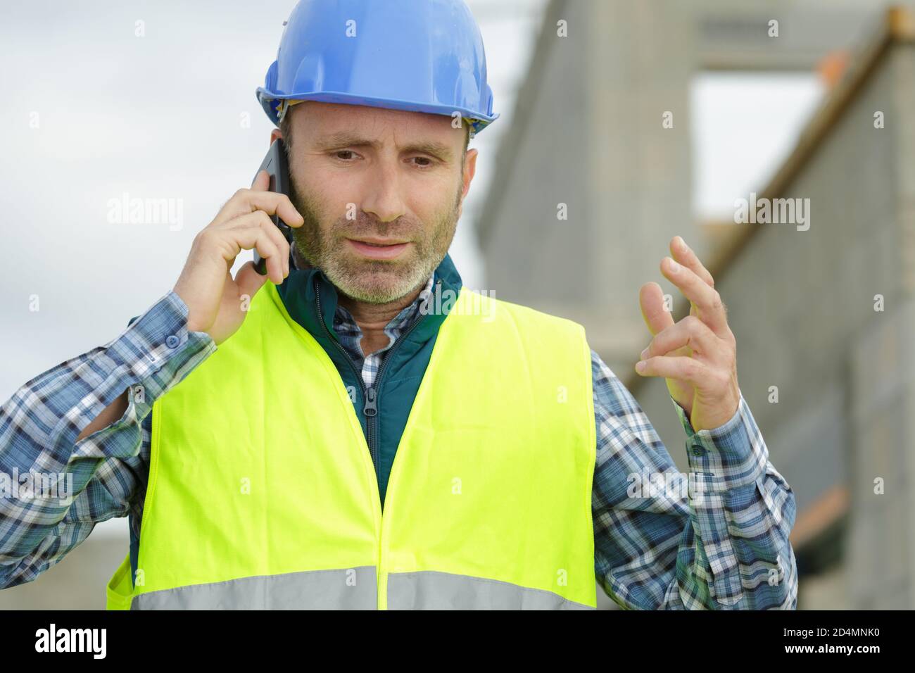 stressed workman gesturing during telephone conversation Stock Photo ...