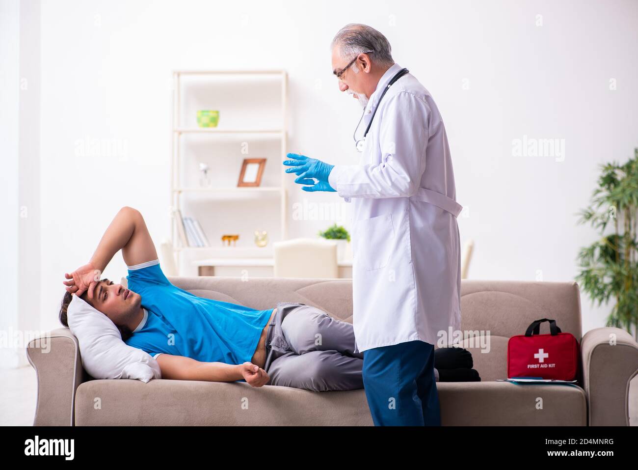 Two doctors visiting sick man at home Stock Photo - Alamy