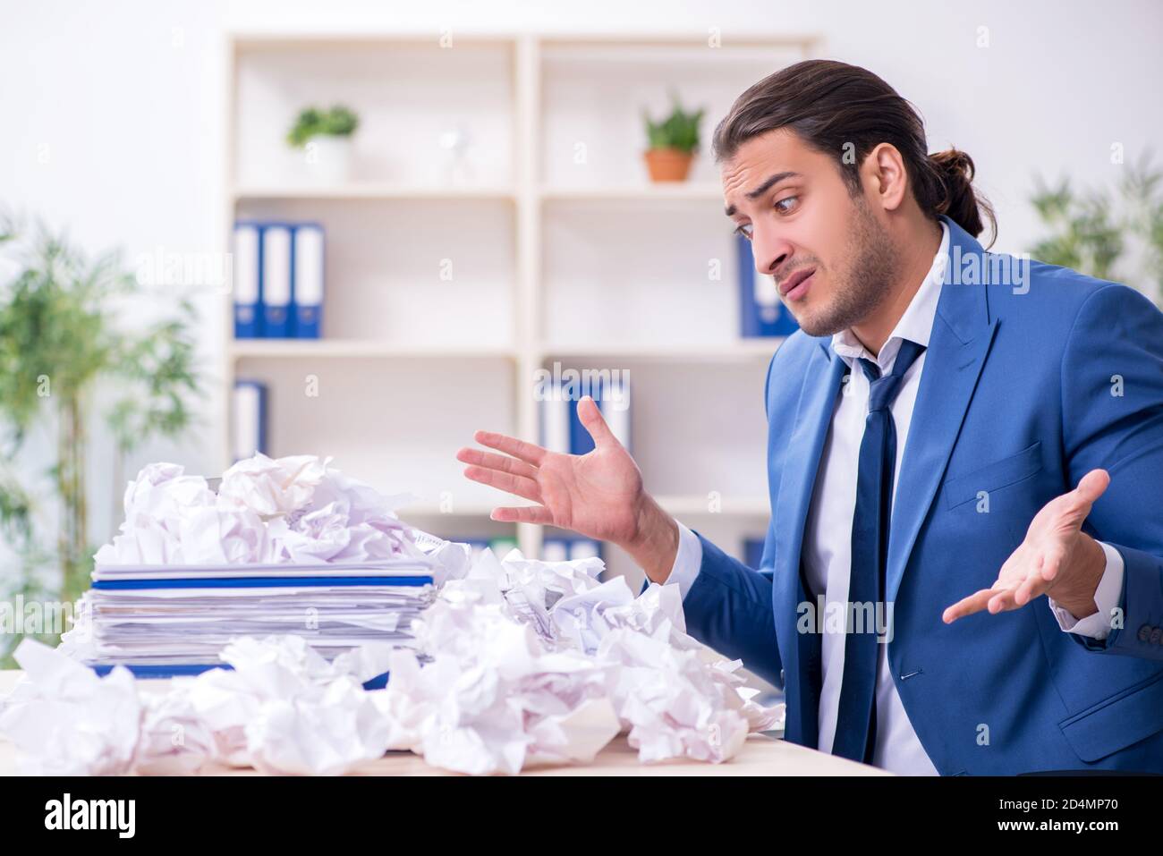 Businessman rejecting ideas with lots of papers Stock Photo - Alamy