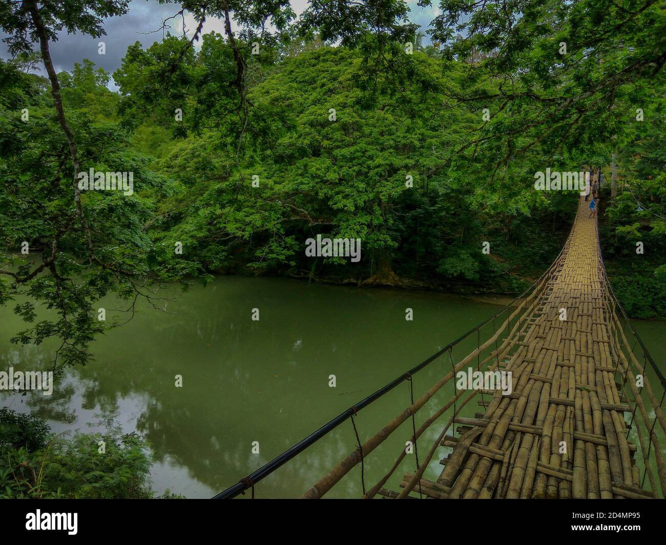 Beautiful footbridge made from bamboo over a river Stock Photo - Alamy