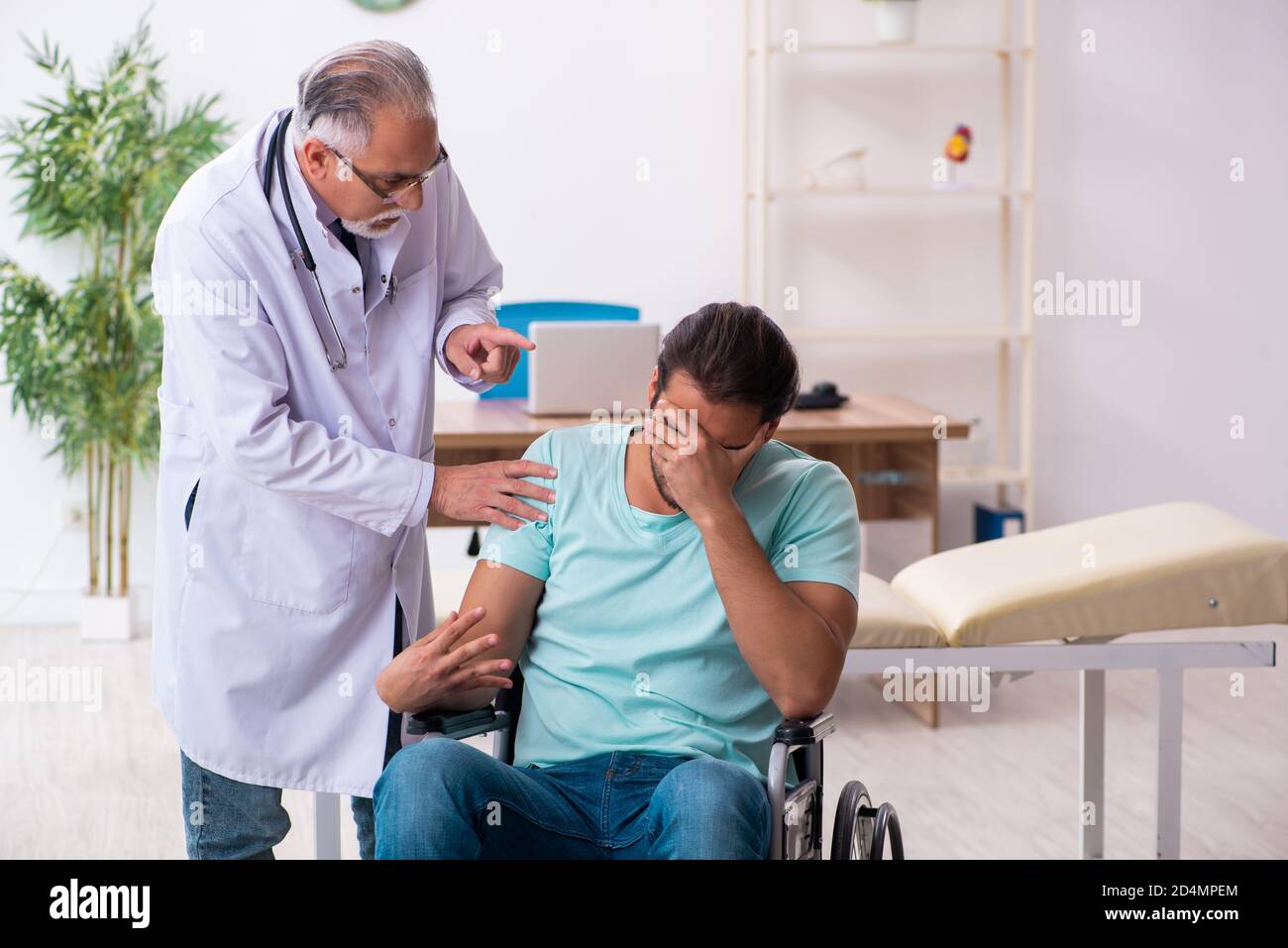Experienced doctor and male patient in wheel-chair Stock Photo - Alamy