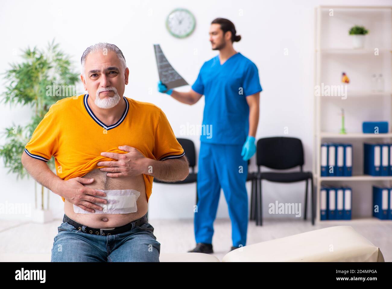 Old man visiting male doctor Stock Photo - Alamy