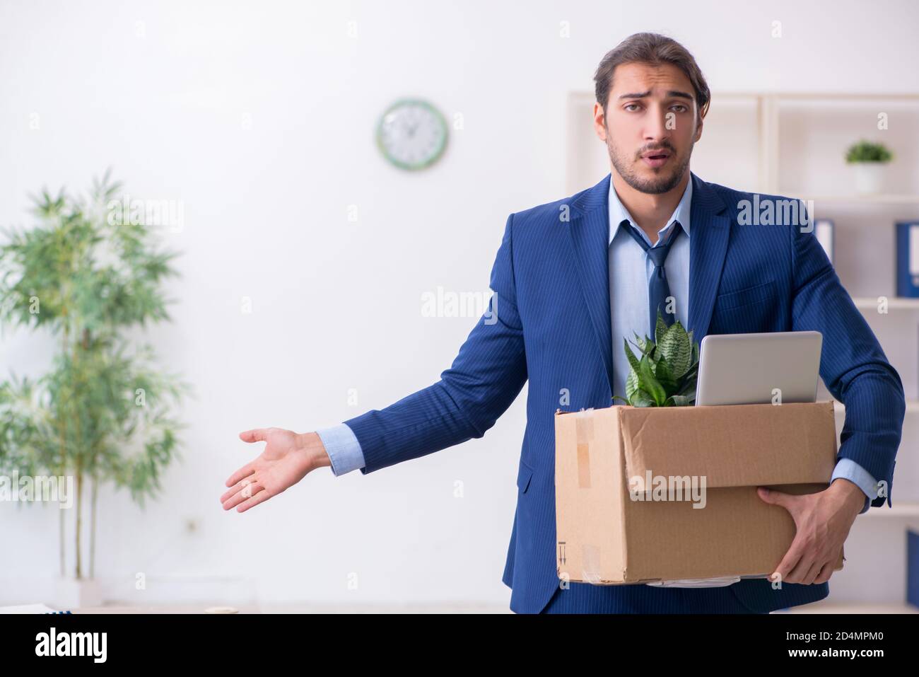 Young man being fired from his workplace Stock Photo - Alamy